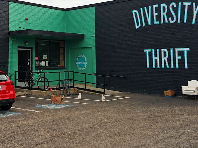 The unmistakable lime-green entrance to Diversity Thrift stands like a beacon for bargain hunters, promising treasures within its unassuming brick walls.