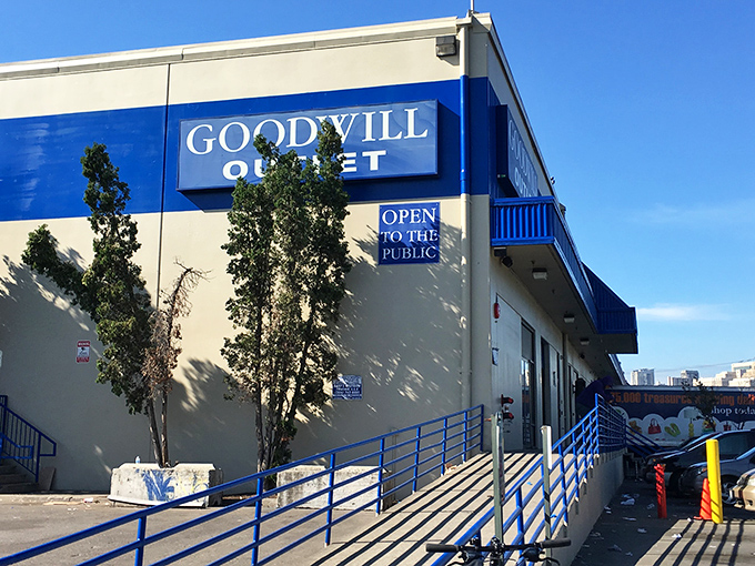 The blue-trimmed exterior of Seattle Outlet Goodwill stands like a portal to bargain dimension&mdash;where treasures await those brave enough to enter. 