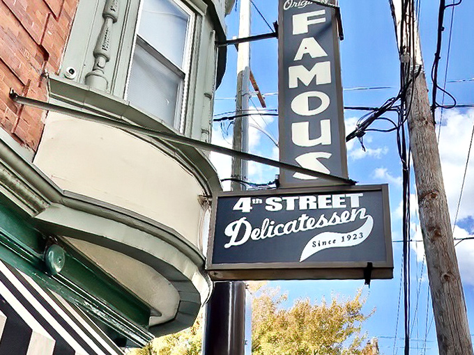 The iconic green and white exterior of Famous 4th Street Delicatessen stands as a beacon of sandwich excellence in Philadelphia's Queen Village neighborhood.