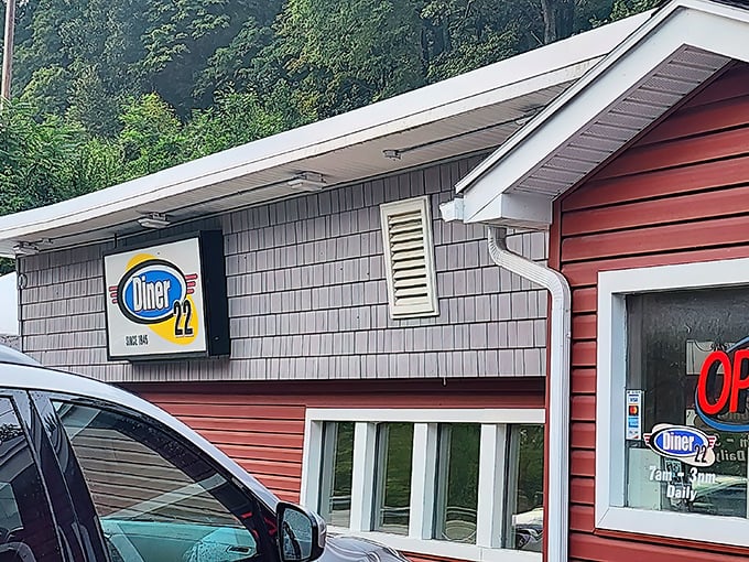 The red siding and glowing "OPEN" sign of Diner 22 isn't just an invitation &ndash; it's a promise of comfort food that awaits within these unassuming walls.