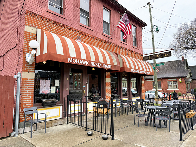 The iconic red brick and striped awning of The Old Mohawk stands as a beacon of comfort in Columbus' German Village. A neighborhood landmark that promises good times inside.