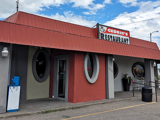 The iconic red-roofed diner with porthole windows stands like a culinary lighthouse for hungry travelers seeking comfort food perfection in Idaho Falls.