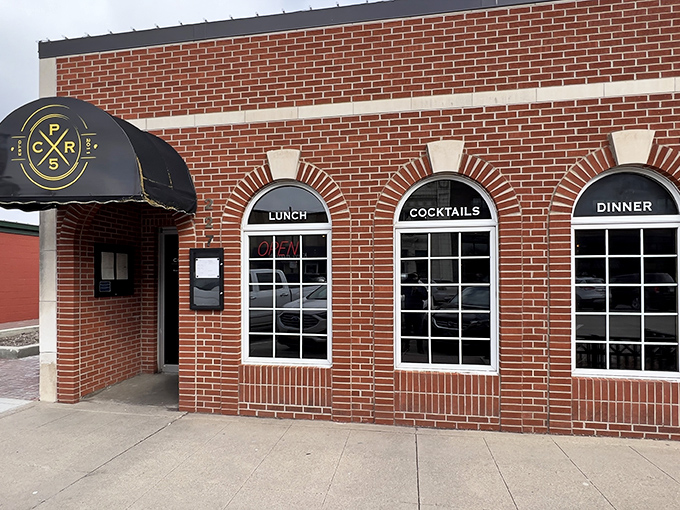 Classic brick charm meets modern comfort at Cooper's on 5th, where "LUNCH" and "COCKTAILS" promise double the happiness. 