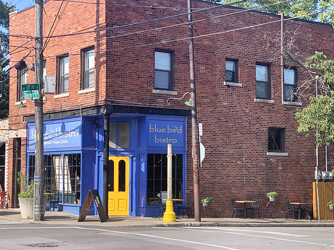 The bright blue storefront with its sunny yellow door stands like a cheerful beacon in Kansas City's Westside neighborhood, promising culinary adventures within.