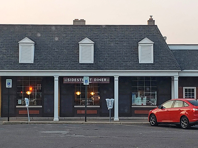 The charming yellow brick exterior of Side Street Diner beckons with its distinctive mansard roof and welcoming entrance. A hidden gem worth seeking out!