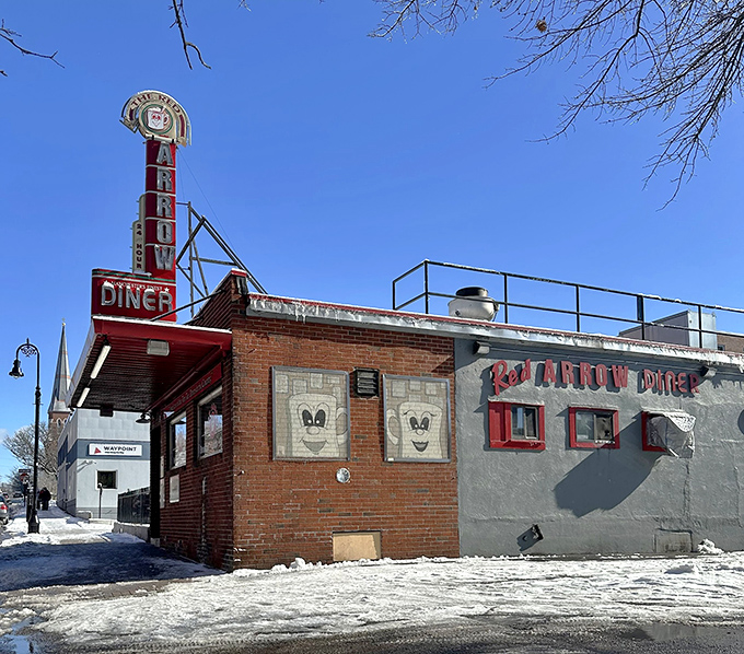 The iconic neon sign beckons hungry travelers like a lighthouse for the famished. This brick-and-mortar time machine has been Manchester's comfort food headquarters for generations.
