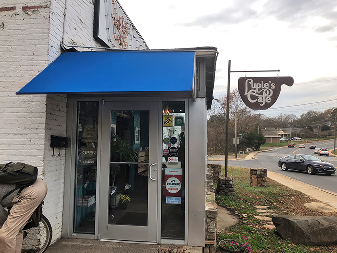 The neon glow of Lupie's sign beckons like a lighthouse for the hungry soul. This unassuming exterior hides Charlotte's comfort food paradise.