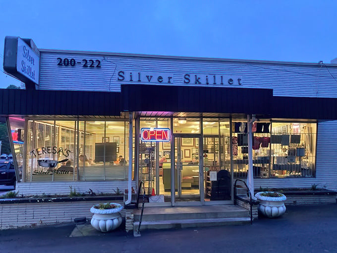 The Silver Skillet's mid-century exterior glows like a time capsule at dusk, beckoning hungry travelers with promises of Southern comfort and nostalgia.