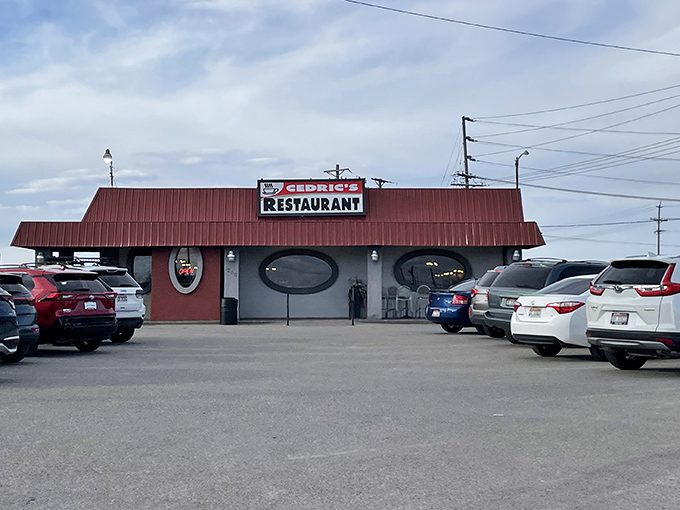 The iconic red-roofed diner with porthole windows stands like a culinary lighthouse for hungry travelers seeking comfort food perfection in Idaho Falls.