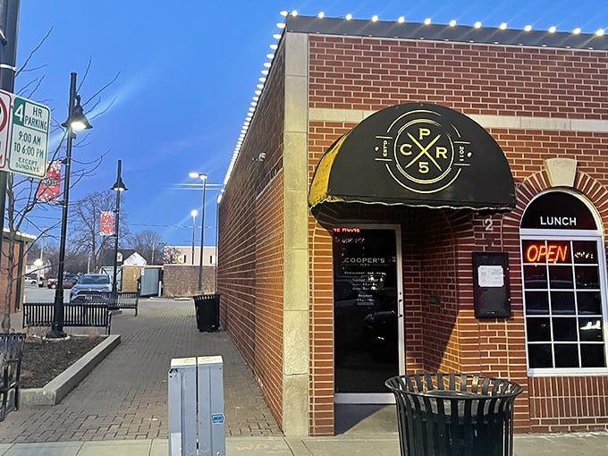 Classic brick charm meets modern comfort at Cooper's on 5th, where "LUNCH" and "COCKTAILS" promise double the happiness. 