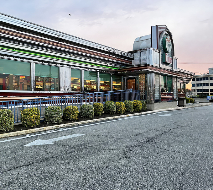 The Double T's neon sign glows like a beacon of comfort food against the twilight sky, promising delicious salvation for hungry travelers.
