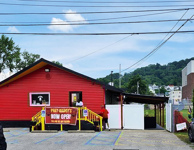 The vibrant red exterior of Phat Daddy's on Da Tracks stands out like a culinary beacon, promising flavor adventures from its humble Charleston hillside perch.
