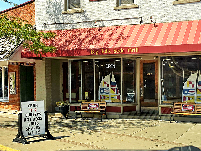 The white brick building with its cherry-red awning stands like a time capsule on Vermilion's corner, promising sweet nostalgia inside.