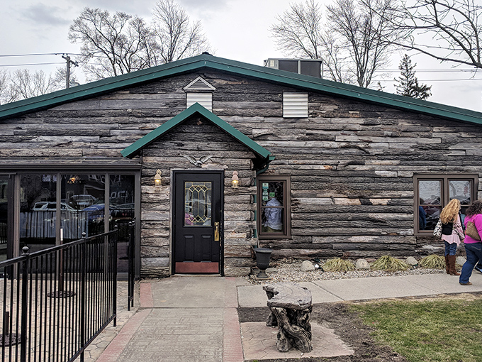 The weathered log cabin exterior with teal trim isn't trying to impress anyone, which is exactly why it does. Authentic Midwestern charm at its finest.