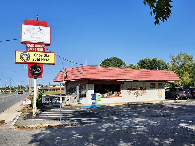 That iconic red roof beckons like a lighthouse for hungry travelers. Rock-Cola's exterior promises a journey back to simpler, more delicious times.