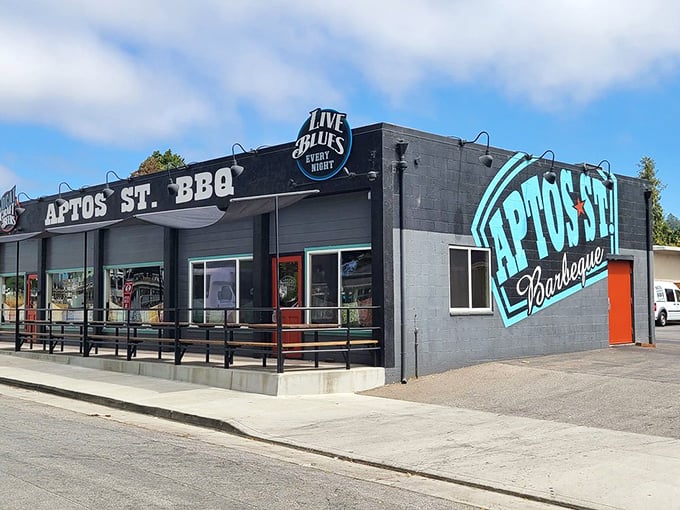 The blue exterior of Aptos St. BBQ stands like a beacon of hope for hungry travelers, promising smoky delights and blues music within.