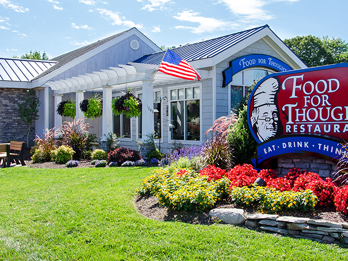 The welcoming exterior of Food For Thought beckons with colorful landscaping and a promise of culinary enlightenment. That American flag isn't just patriotic&mdash;it's signaling your taste buds to stand at attention.