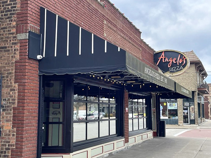 The unassuming brick fa&ccedil;ade of Angelo's Pizza hides culinary treasures within. Like a superhero's secret identity, it's modest on the outside, magnificent on the inside.