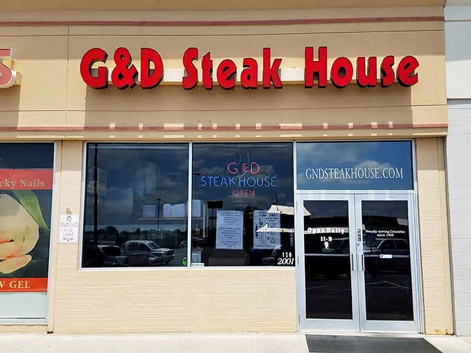 The iconic neon sign of G & D Steakhouse glows like a beacon for hungry travelers, promising unpretentious comfort and satisfying meals in Columbia.