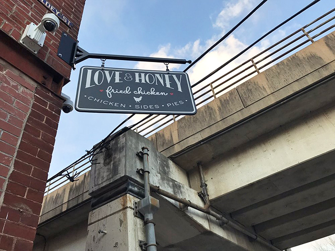The iconic black sign against red brick announces your arrival at chicken paradise. No fancy frills needed when what's inside speaks this loudly.