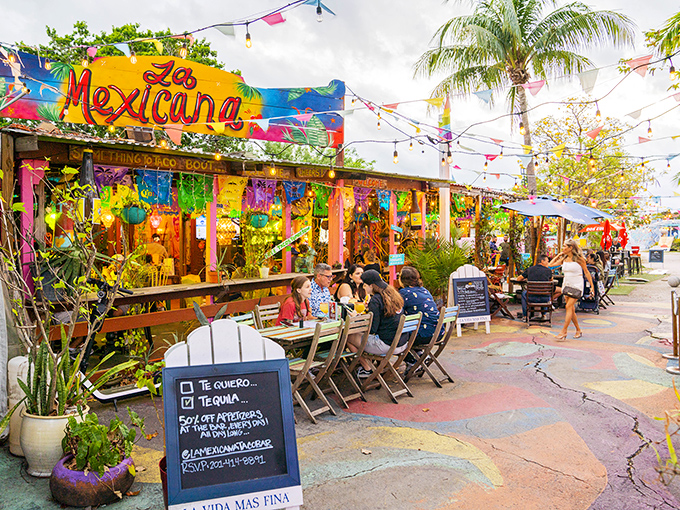 Welcome to paradise! La Mexicana's charming outdoor entrance, with its colorful umbrellas and lush greenery, promises a tropical escape from everyday life.