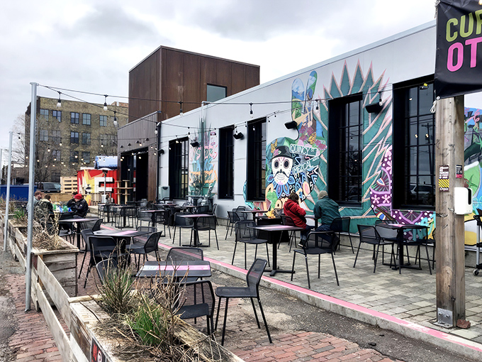 Centro's neon sign glows like a turquoise beacon against the twilight sky, promising Mexican delights in Northeast Minneapolis's urban landscape.