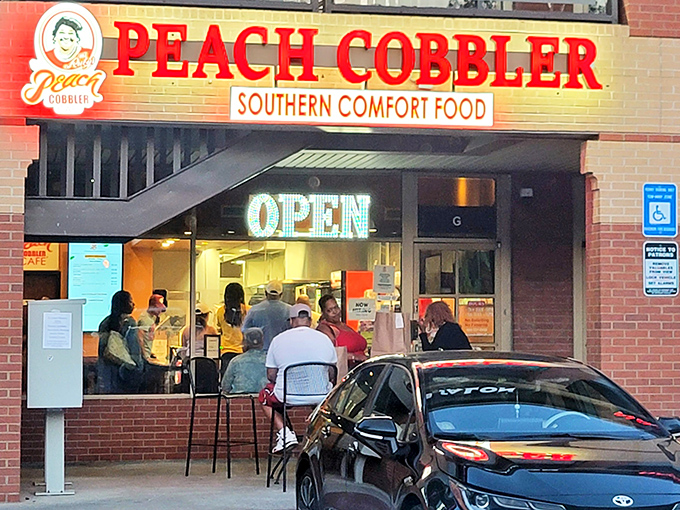 The bright red "PEACH COBBLER" sign beckons like a siren song to hungry travelers. Resistance is futile when Southern comfort food calls your name.
