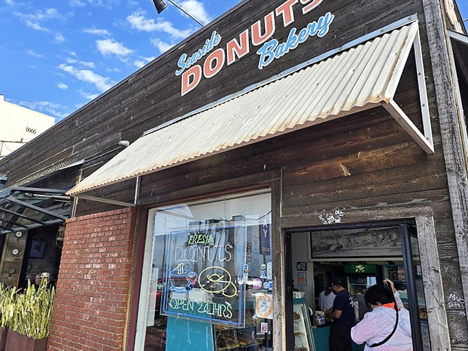 The unassuming facade of Seaside Donuts Bakery hides a world of fried dough magic. That "OPEN 24HRS" sign is the bat signal for donut lovers everywhere.