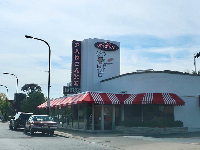 The iconic white building with red-and-white awnings stands like a breakfast beacon, calling hungry pilgrims from across Illinois to pancake paradise.