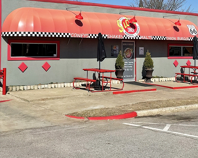 The iconic red awning of Sid's Diner beckons hungry travelers along Route 66 like a culinary lighthouse in a sea of chain restaurants.