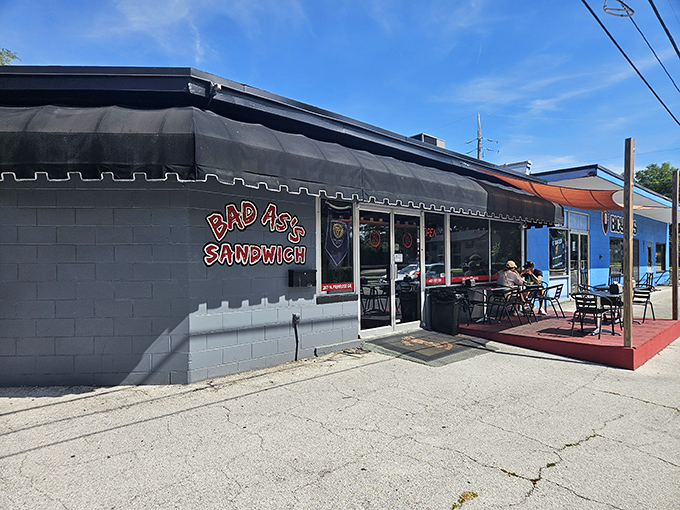 The unassuming gray exterior hides sandwich greatness within. Like a culinary speakeasy, Bad As's bold red sign is your invitation to flavor paradise.