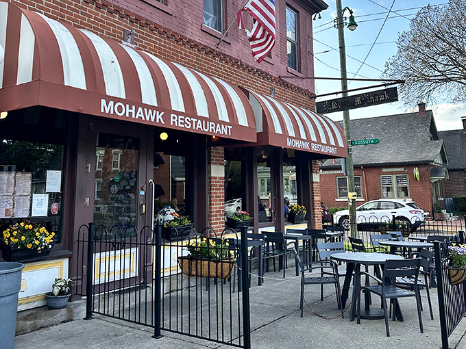 The iconic red brick and striped awning of The Old Mohawk stands as a beacon of comfort in Columbus' German Village. A neighborhood landmark that promises good times inside.