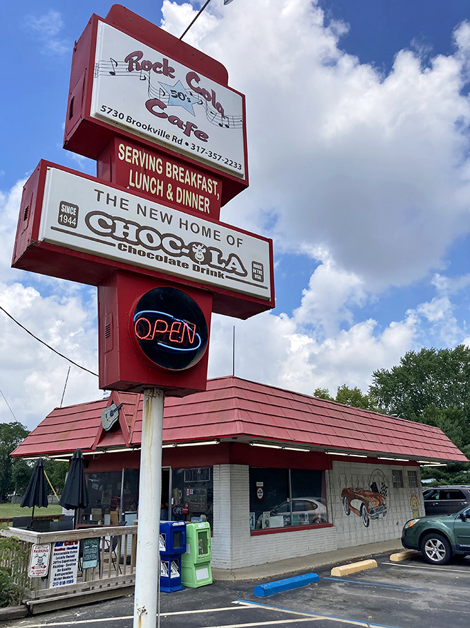 The classic red-roofed exterior of Rock-Cola 50's Cafe stands like a time capsule on Indy's east side, promising nostalgic flavors and memories with every visit.