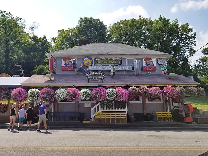 The Turf Club's exterior is a delightful contradiction &ndash; part roadside attraction, part culinary institution, with vintage figurines standing guard over burger paradise.