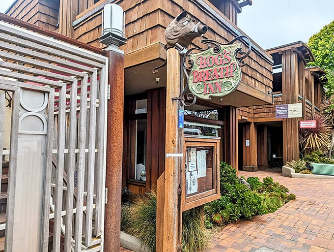 The rustic wooden exterior of Hog's Breath Inn welcomes you like an old friend, its iconic sign promising culinary adventures in the heart of charming Carmel-By-The-Sea.