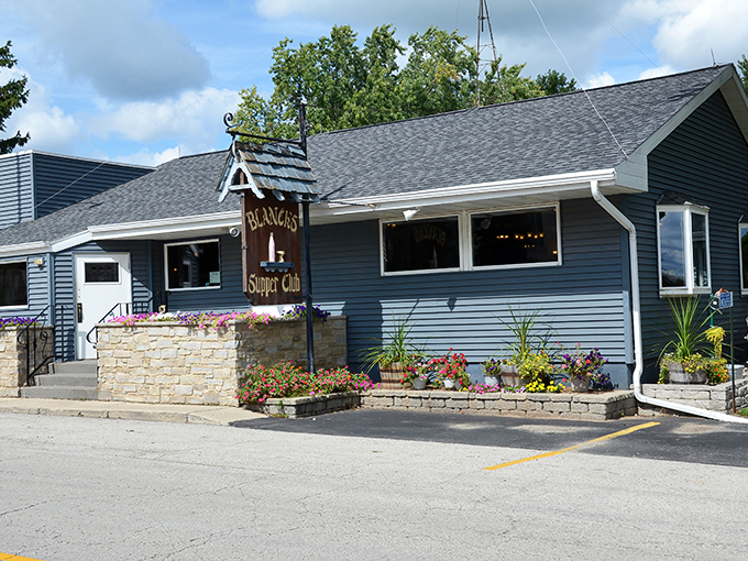 The unassuming blue exterior of Blanck's Supper Club in Malone, where culinary magic happens without fancy pretense or big-city fanfare.