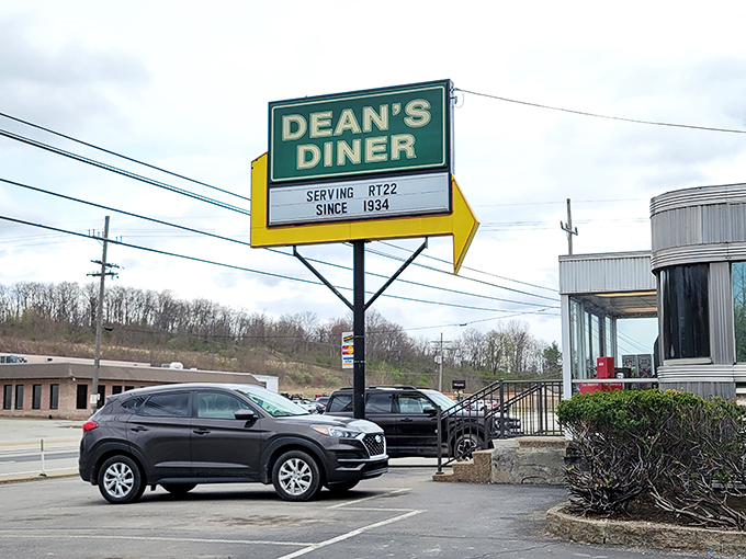 That iconic yellow arrow sign has been guiding hungry travelers to Dean's Diner since 1934, like a neon North Star of comfort food.