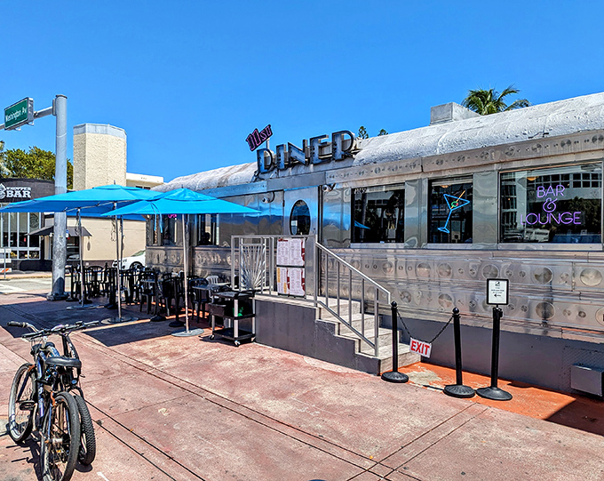 The gleaming stainless steel exterior of 11th Street Diner shines like a beacon of nostalgia under Miami's blue skies, promising comfort food and air conditioning in equal measure.