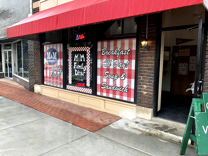 The bright red awning of M & M Family Diner beckons like a culinary lighthouse on Logan's main street, promising comfort and satisfaction within.