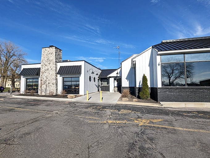 The bright blue awning of Jolly Rogers stands like a maritime beacon on Port Clinton's shoreline, promising seafood treasures within these humble walls.
