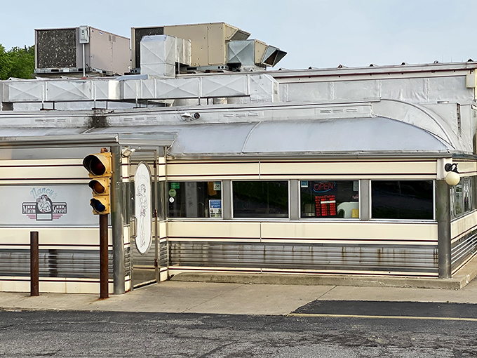 The gleaming stainless steel exterior of Nancy's Main Street Diner catches the morning light like a time machine waiting to transport you back to simpler times.