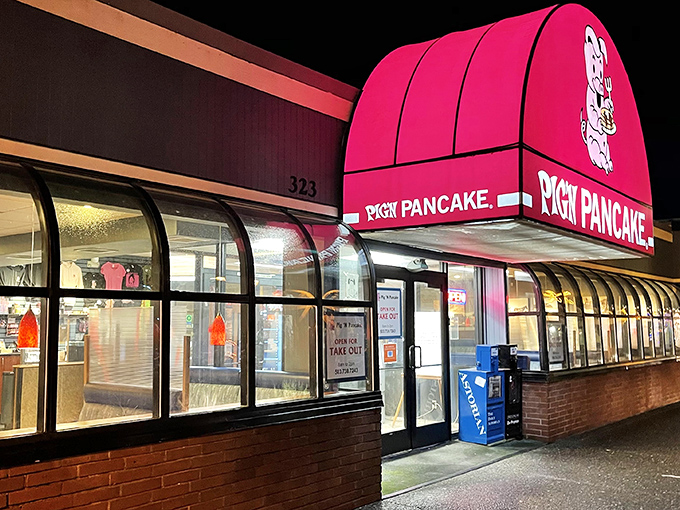 The iconic red and blue exterior of Pig 'N Pancake stands as a beacon of breakfast hope on the Oregon coast, promising comfort food salvation to hungry travelers.