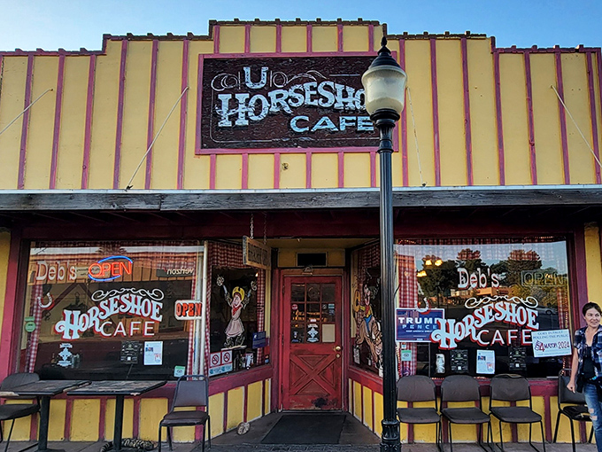 The yellow and red facade of Horseshoe Cafe stands like a beacon of breakfast hope on Wickenburg's main street, promising culinary comfort within those Western-themed walls.