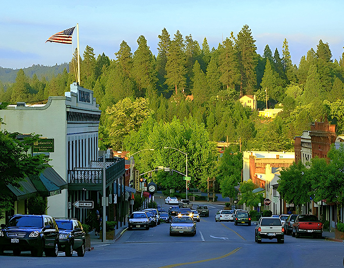 Historic buildings line Grass Valley's Main Street, their colorful facades creating a living museum where Gold Rush history and modern life dance together.