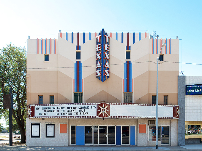 The iconic Sweetwater sign stands tall against that impossibly blue Texas sky, like a beacon calling weary wallets to the promised land of affordability.