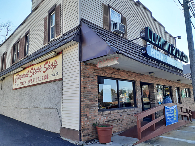 The unassuming brick fa&ccedil;ade of Claymont Steak Shop stands like a culinary lighthouse, beckoning hungry travelers with its no-nonsense promise of "PIZZA &bull; SUBS &bull; STEAKS."
