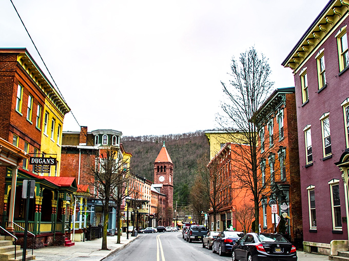 Broadway beckons with its rainbow of Victorian facades, where the clock tower stands sentinel over a street that time politely decided to respect.