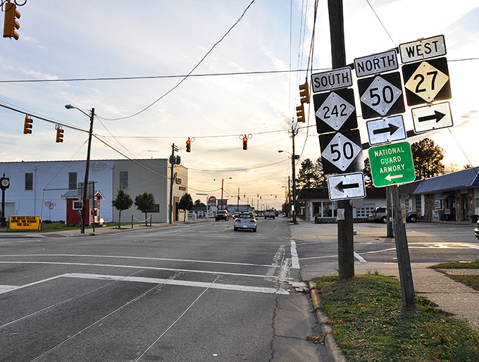 Highway junction signs create a roadmap of possibilities in Benson, where the crossroads of small-town charm and convenience meet under Carolina's generous sky.