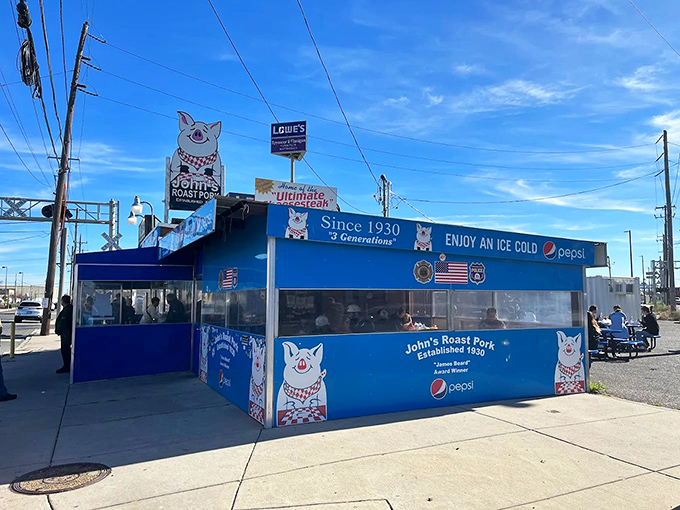 The bright blue beacon of sandwich salvation stands proudly in South Philly, its cartoon pig mascot practically winking at hungry pilgrims.