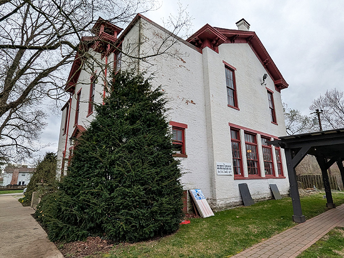 The white brick exterior with distinctive red trim stands as a testament to 1860s architecture, where lessons in arithmetic have given way to lessons in flavor.
